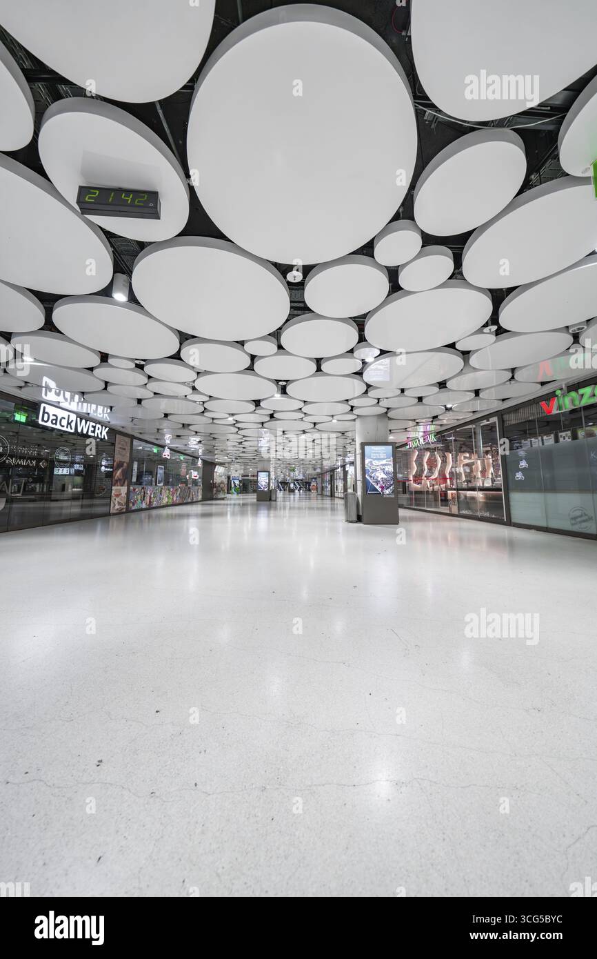 Light-flooded mall with modern round ceiling panels, Munich, Germany ...