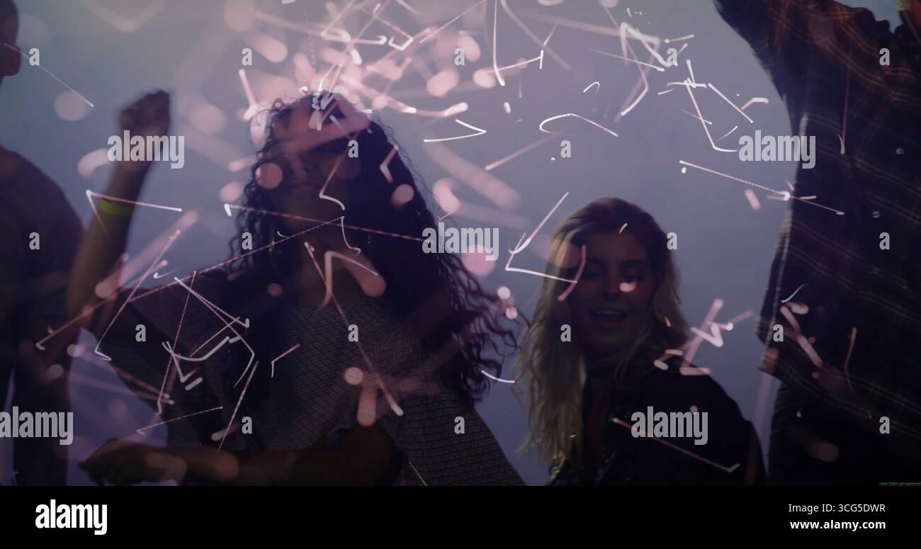 Dancing group of four friends swaying inside dimly lit club, with ...