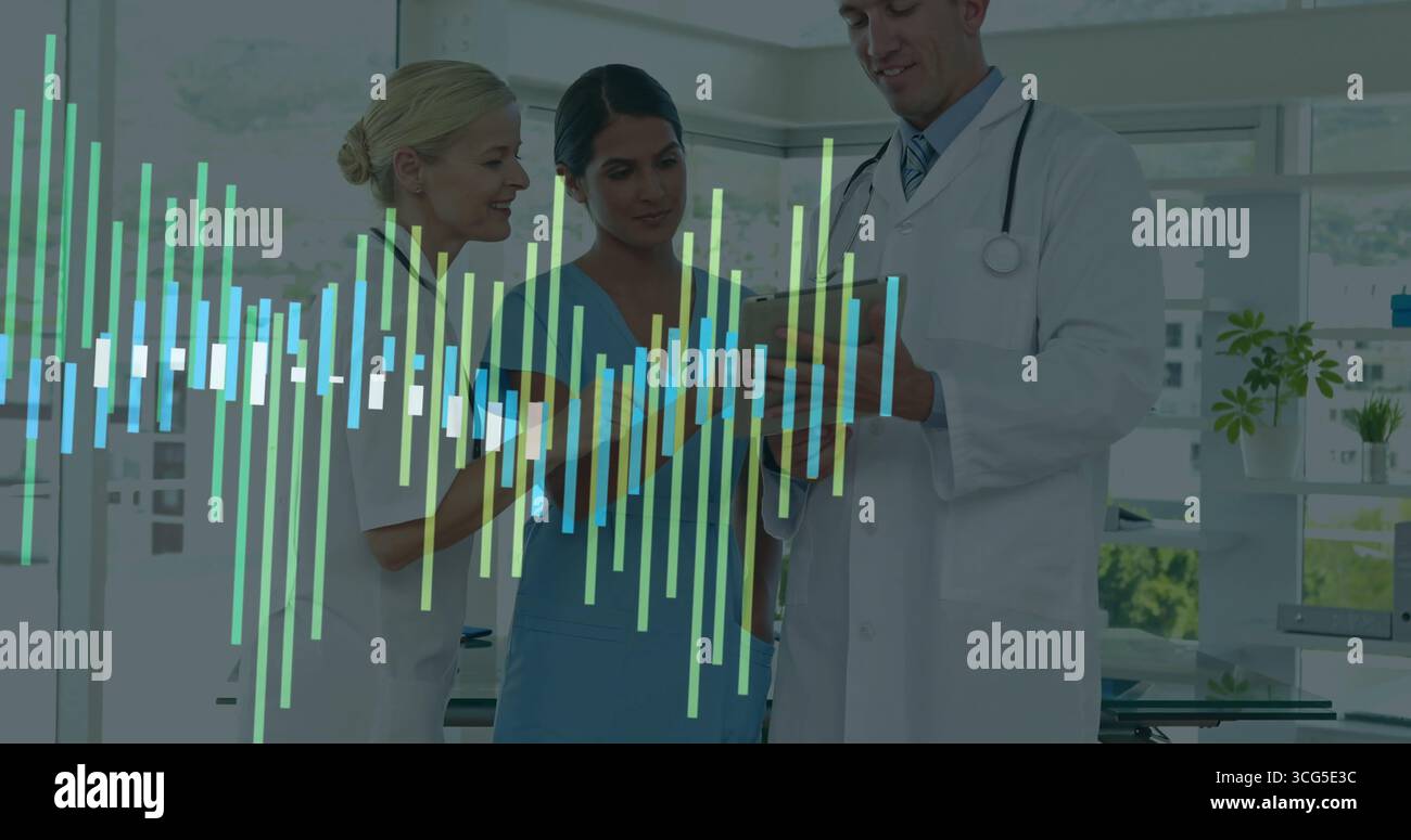 Medical team in medical uniforms examining tablet screen in clinic room ...