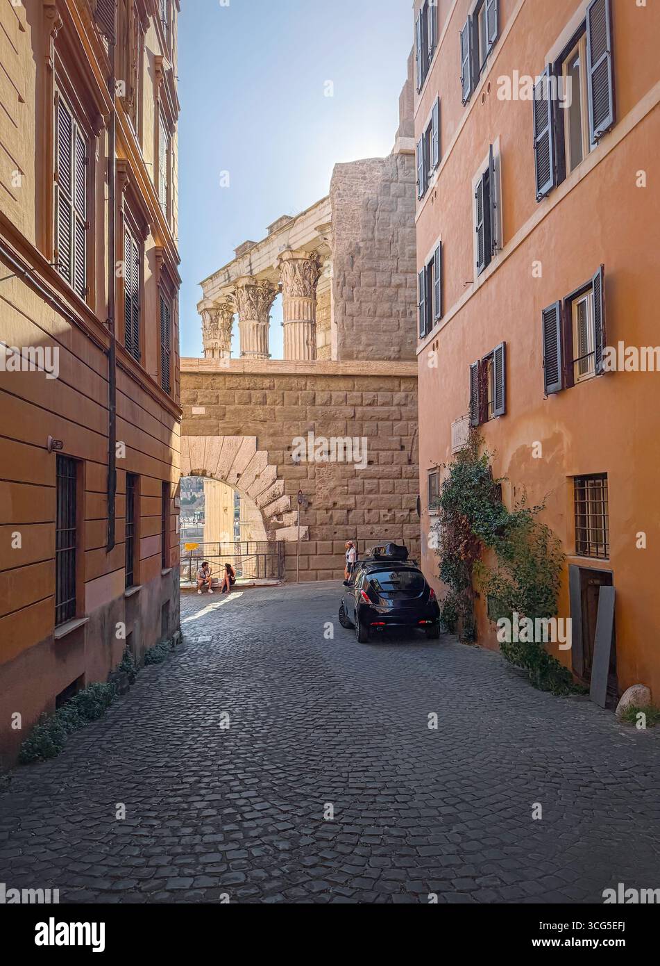 ROME, ITALY - AUGUST 01, 2025 view down a cobblestone roman street ...