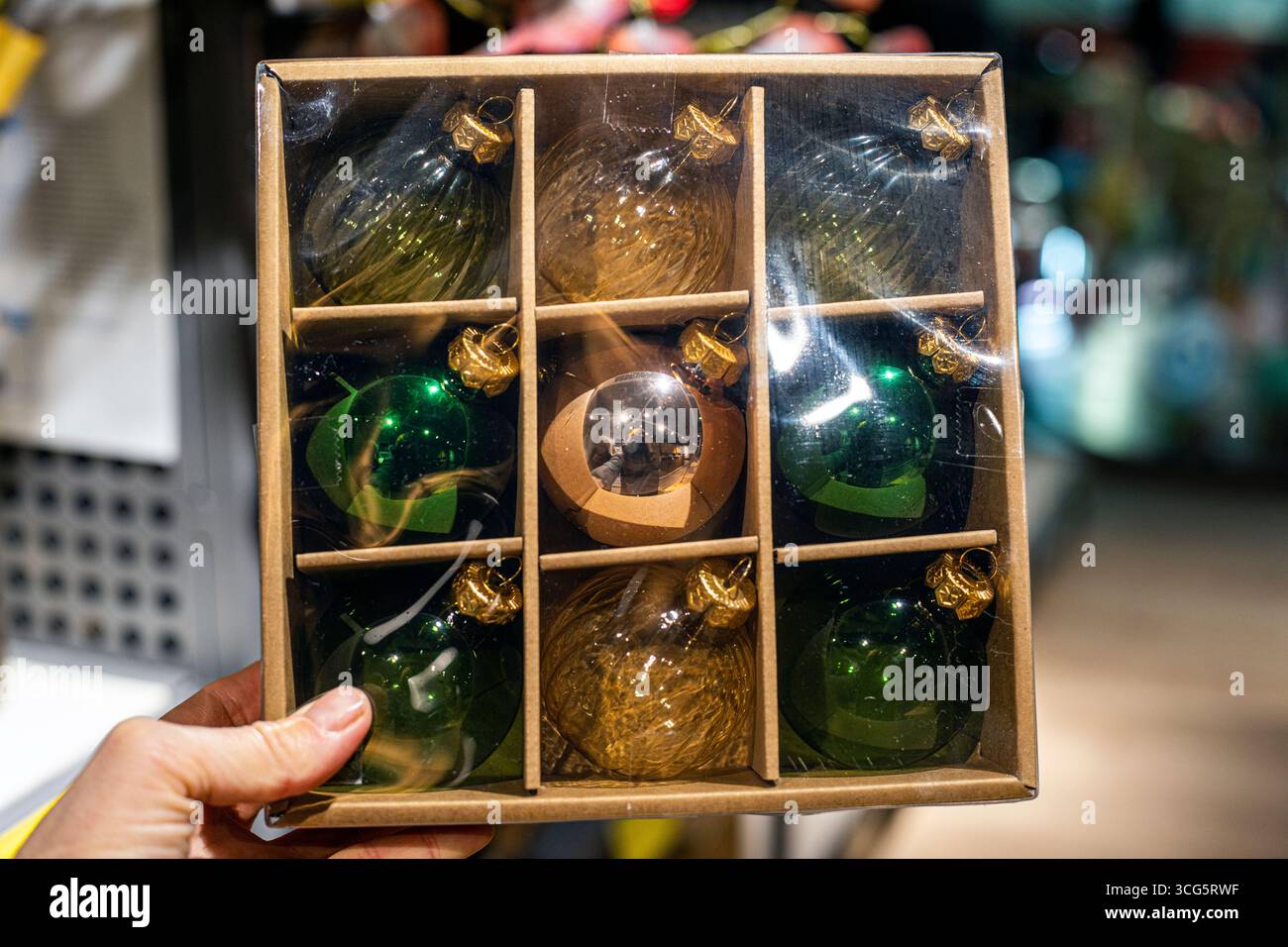 choosing decorative balls for a Christmas tree in a supermarket Stock ...