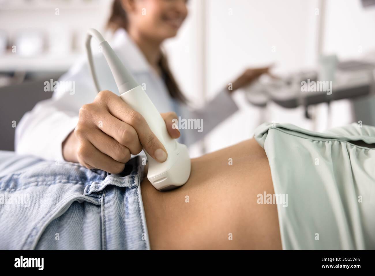 Hand of ultrasound diagnosing doctor examining patient Stock Photo - Alamy