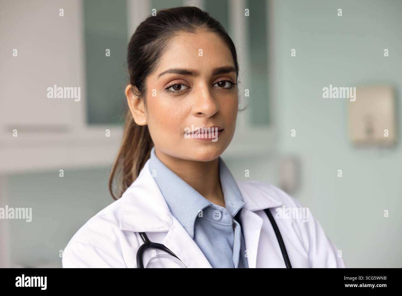 Positive beautiful Indian doctor woman posing for portrait Stock Photo ...