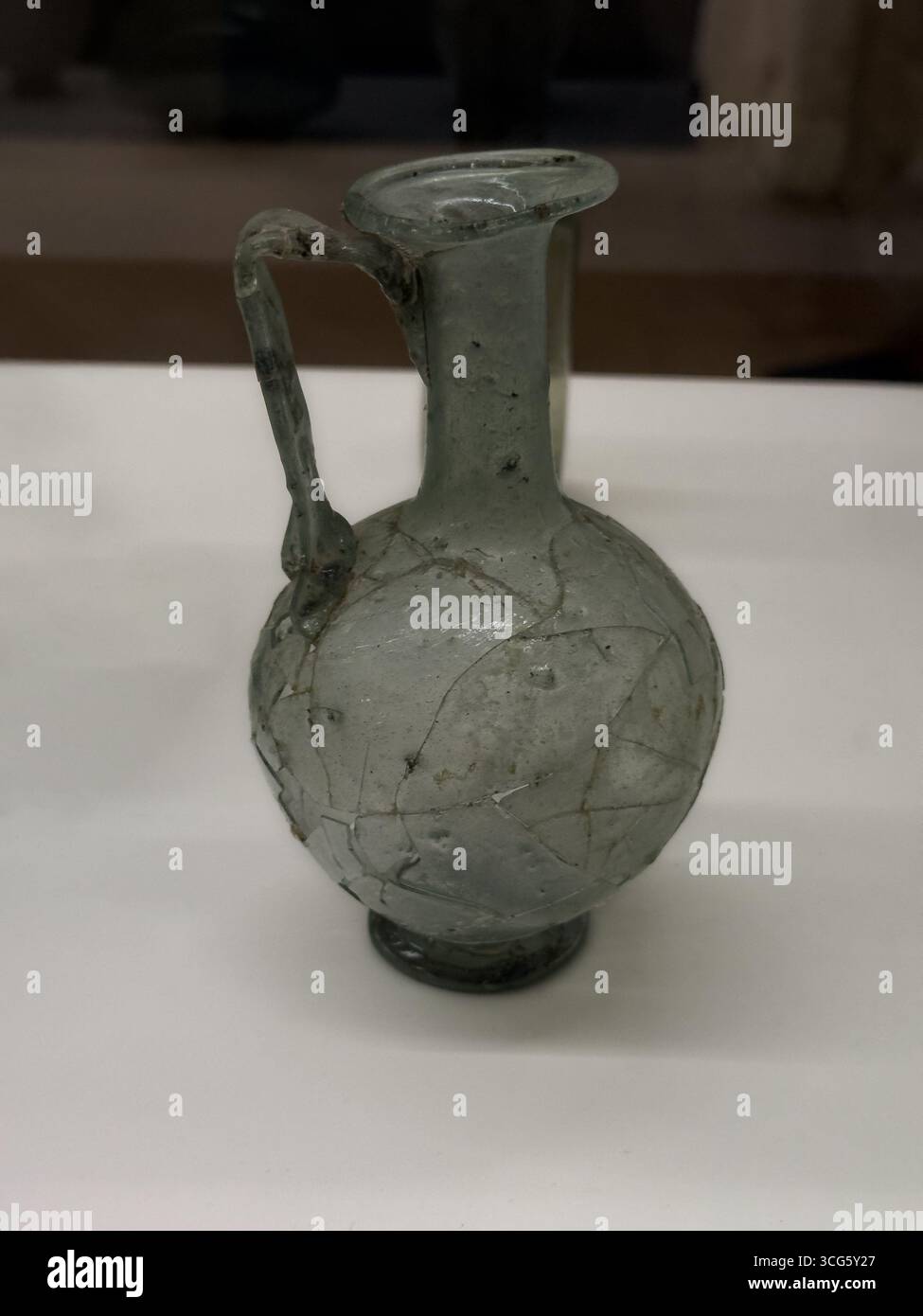 Delicate Roman jug made of transparent glass with single handle and ...