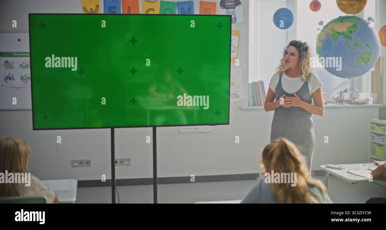 Modern Classroom: Female Teacher Teaching Primary School Children Using ...