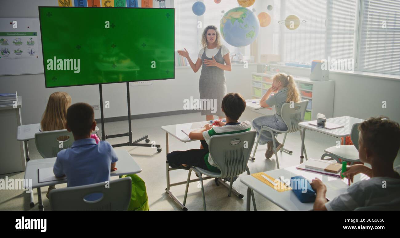 Female Teacher Educating Elementary School Students During Lesson in ...