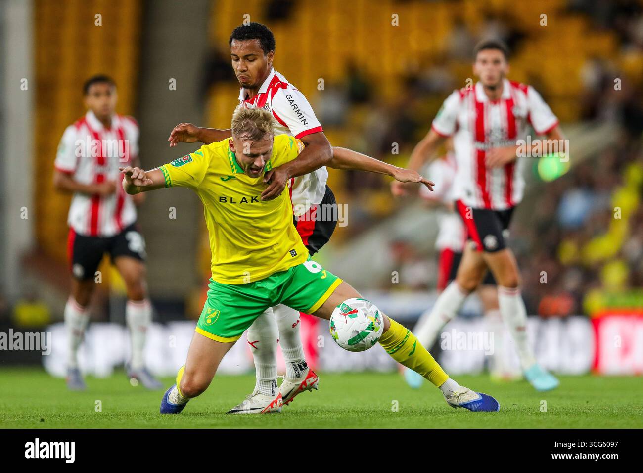Harry Darling of Norwich City is challenged by Cameron Archer of ...