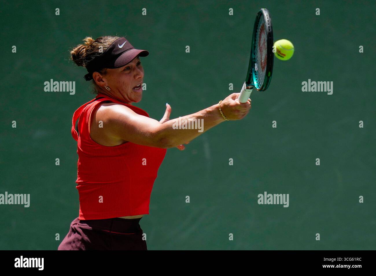 Amanda Anisimova, of the United States, returns a shot to Kimberly ...