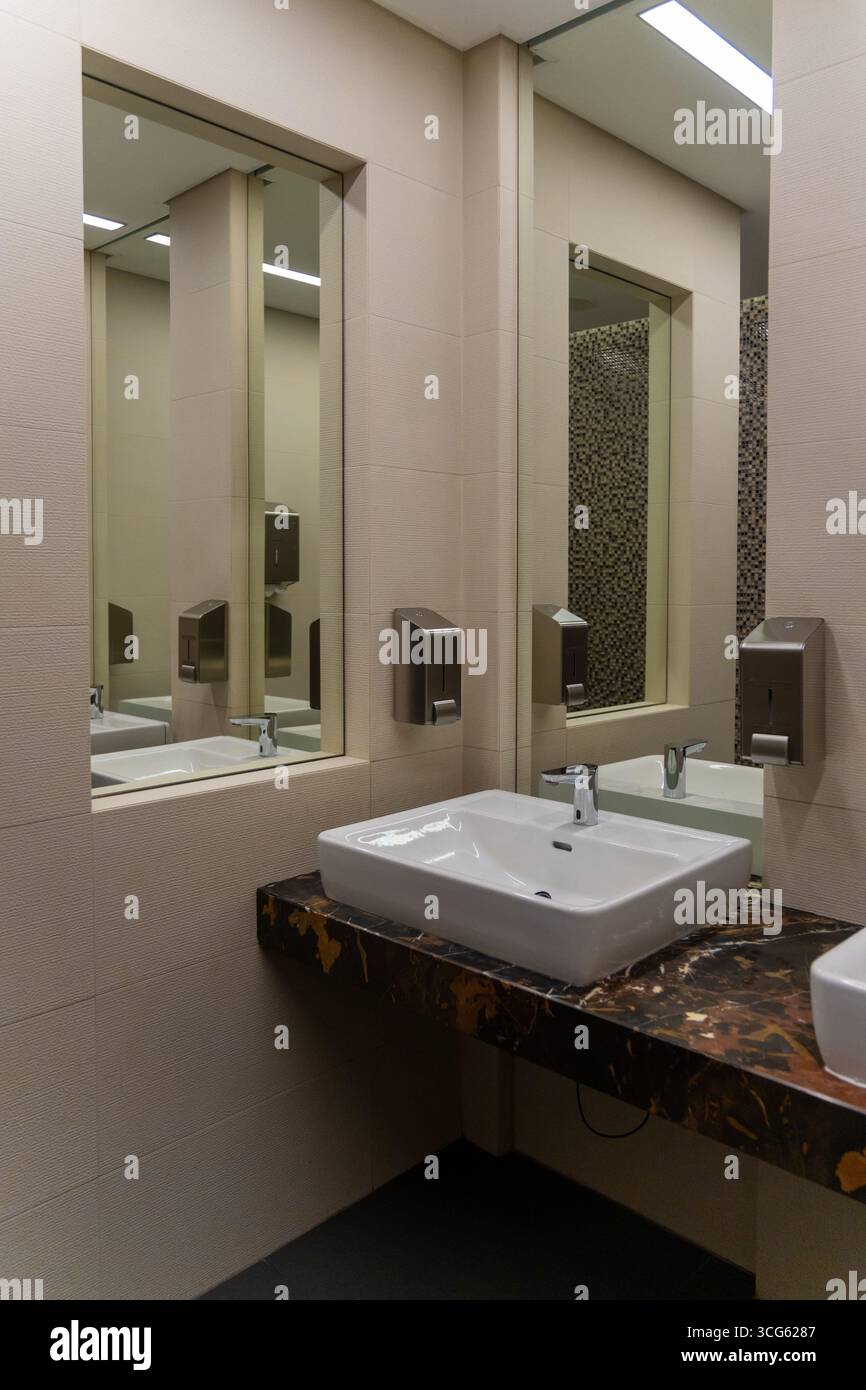 Modern restaurant restroom interior with sinks, mirrors, and soap ...
