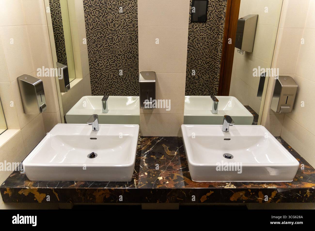 Modern restaurant restroom interior with sinks, mirrors, and soap ...