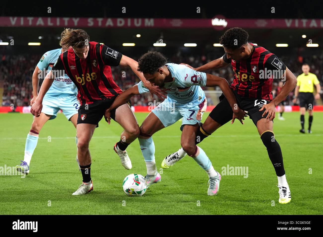 Brentford's Kevin Schade (centre) battles for the ball with Bournemouth ...