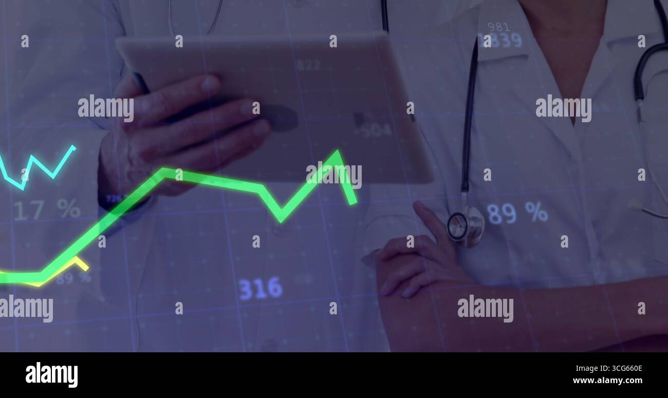 Standing doctors reviewing tablet data in clinic, with stethoscopes and ...