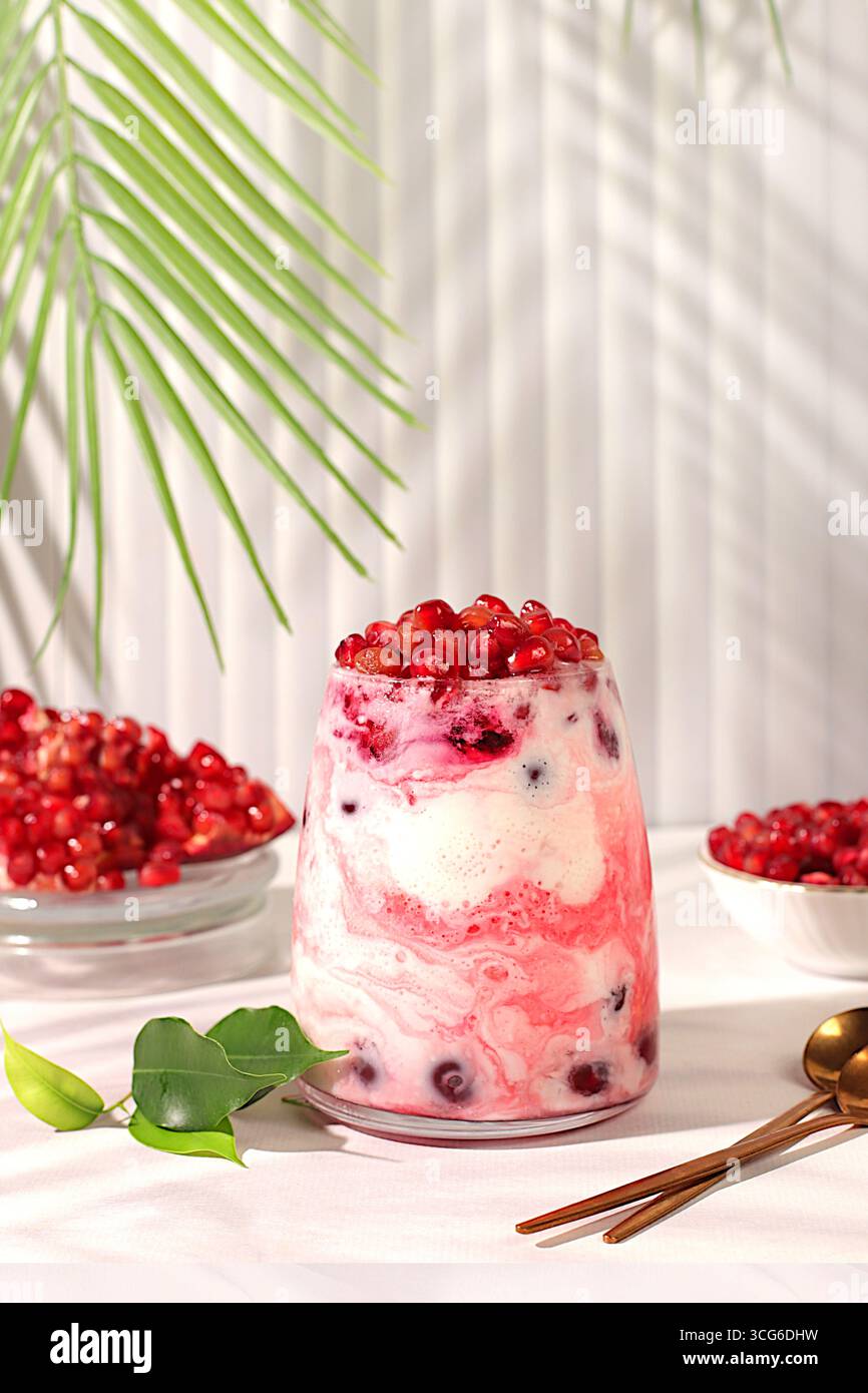 Modern still life with berries and drinks. Pomegranate yogurt with ...