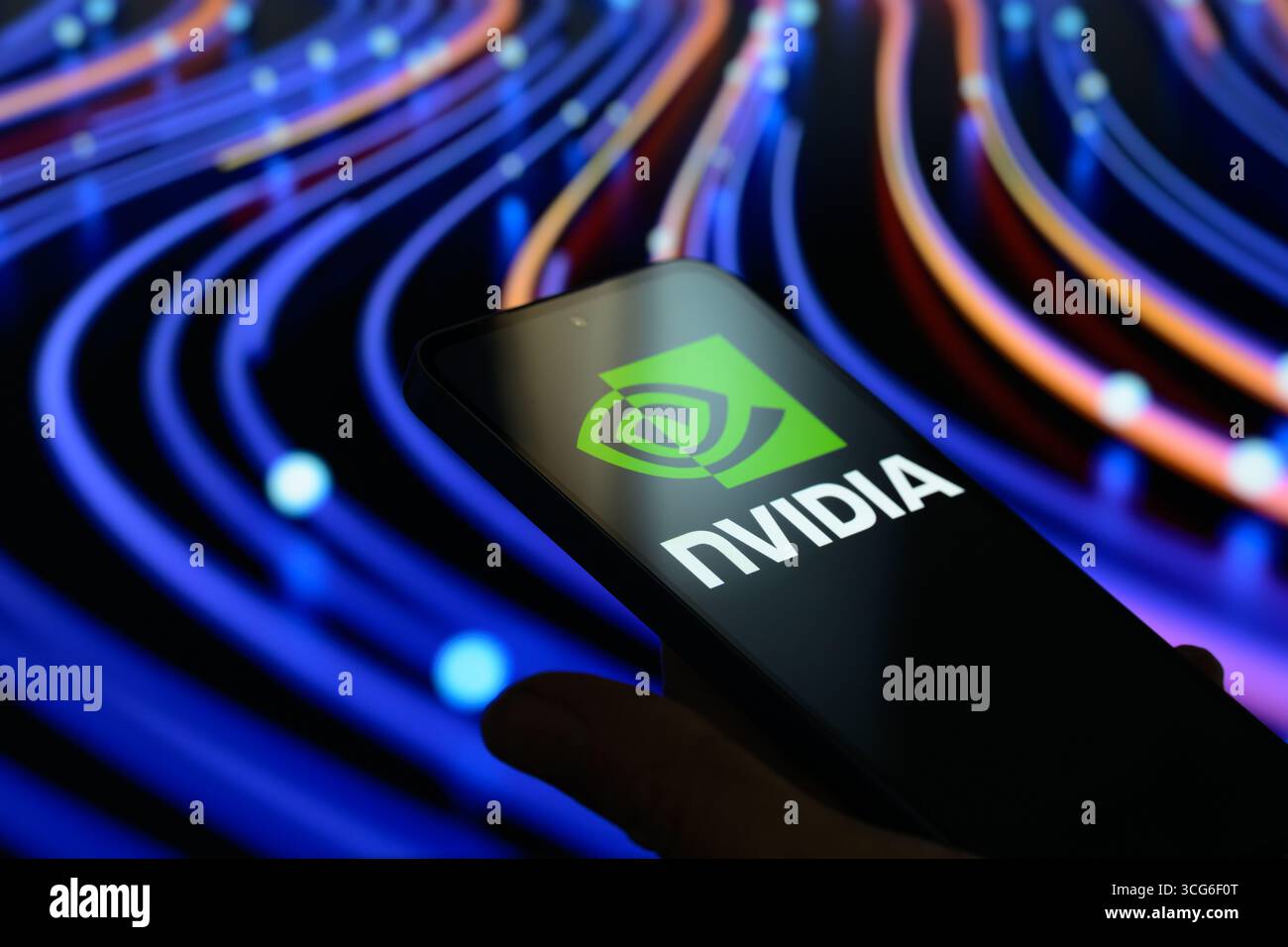 The NVIDIA logo is being displayed on a mobile phone, in this photo ...