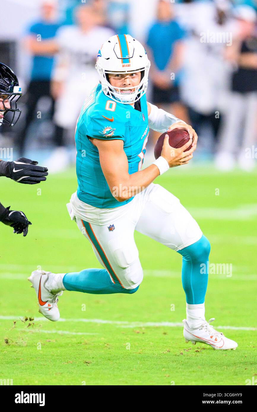 Miami Dolphins quarterback Zach Wilson (0) runs with the ball during an ...