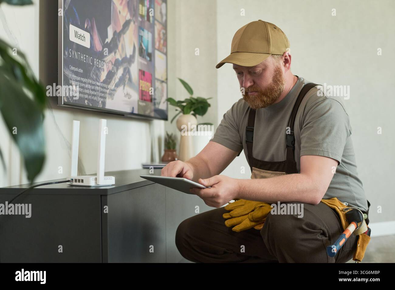 Middle aged Caucasian man with beard wearing work uniform sitting near ...