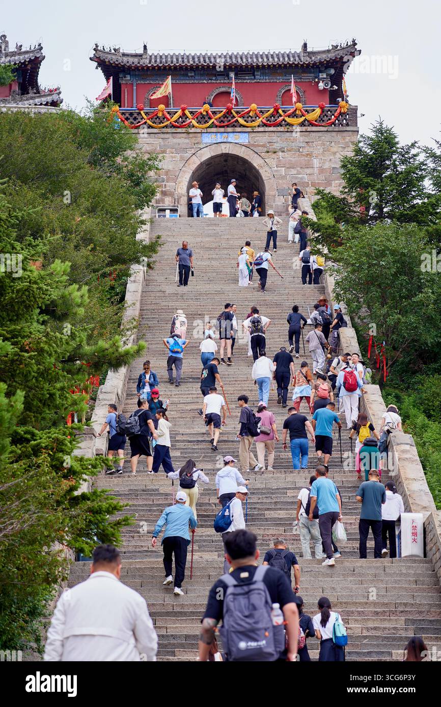 People climbing the famous old staircase to Taishan or Mount Tai summit ...