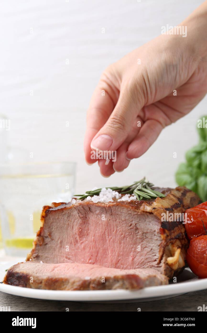 Woman salting roasted beef hi-res stock photography and images - Alamy