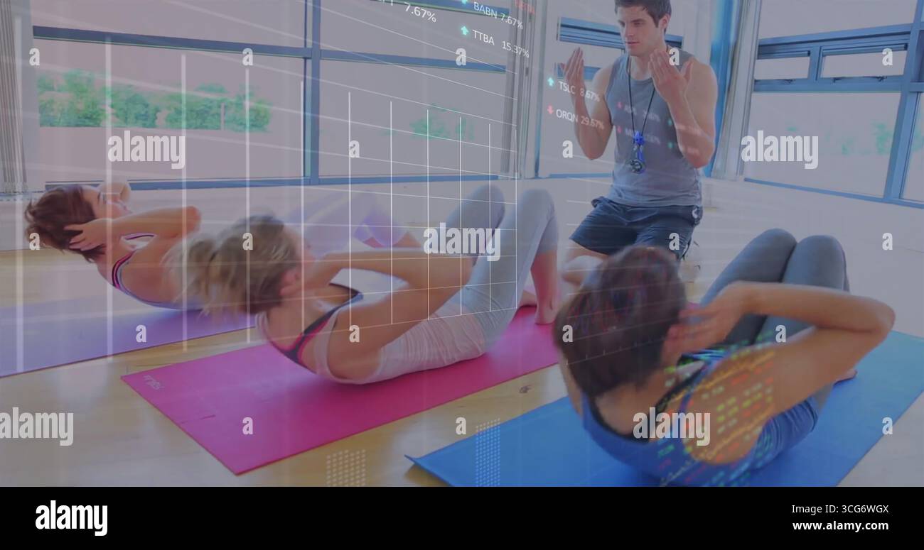 Leading trainer guiding two women doing crunches on mats by windows ...