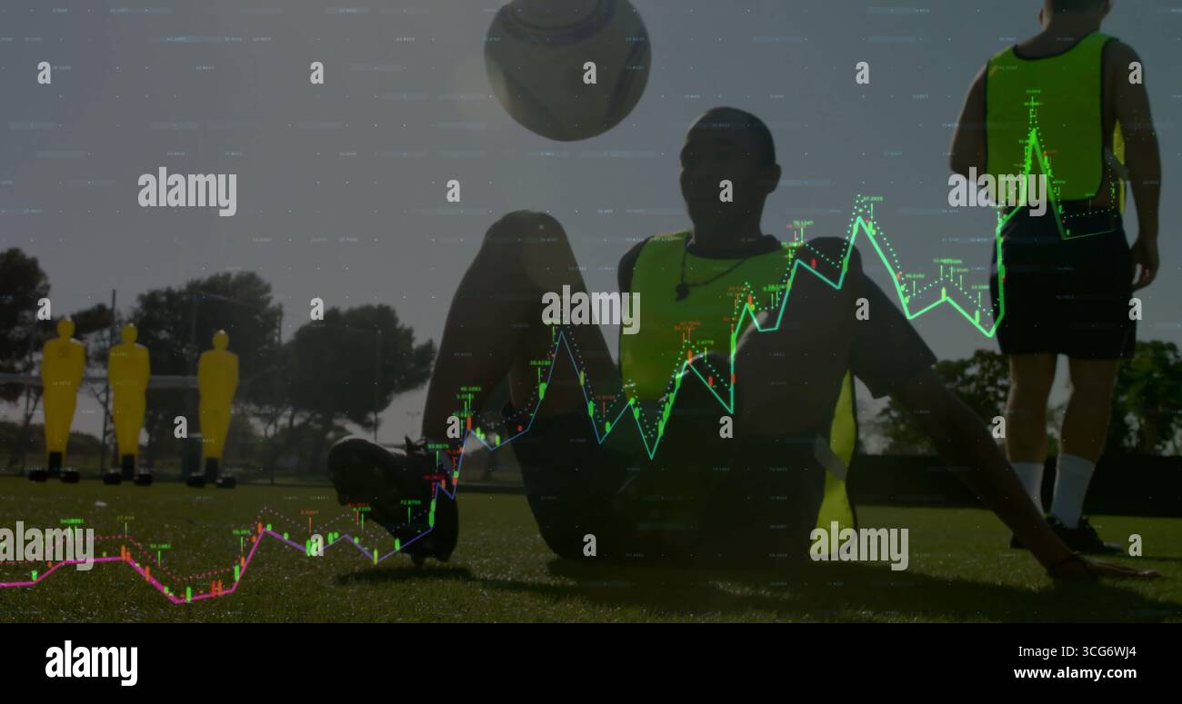 Practicing player wearing vest balancing ball on pitch, with mannequins ...