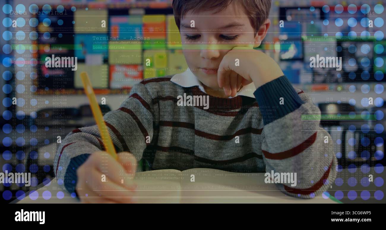 Writing student in gray sweater in coding classroom with monitors ...
