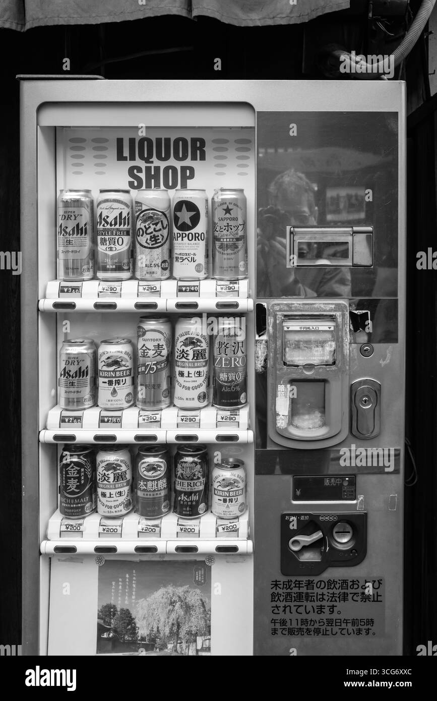 A black and white image of a vending machine in Japan selling an ...