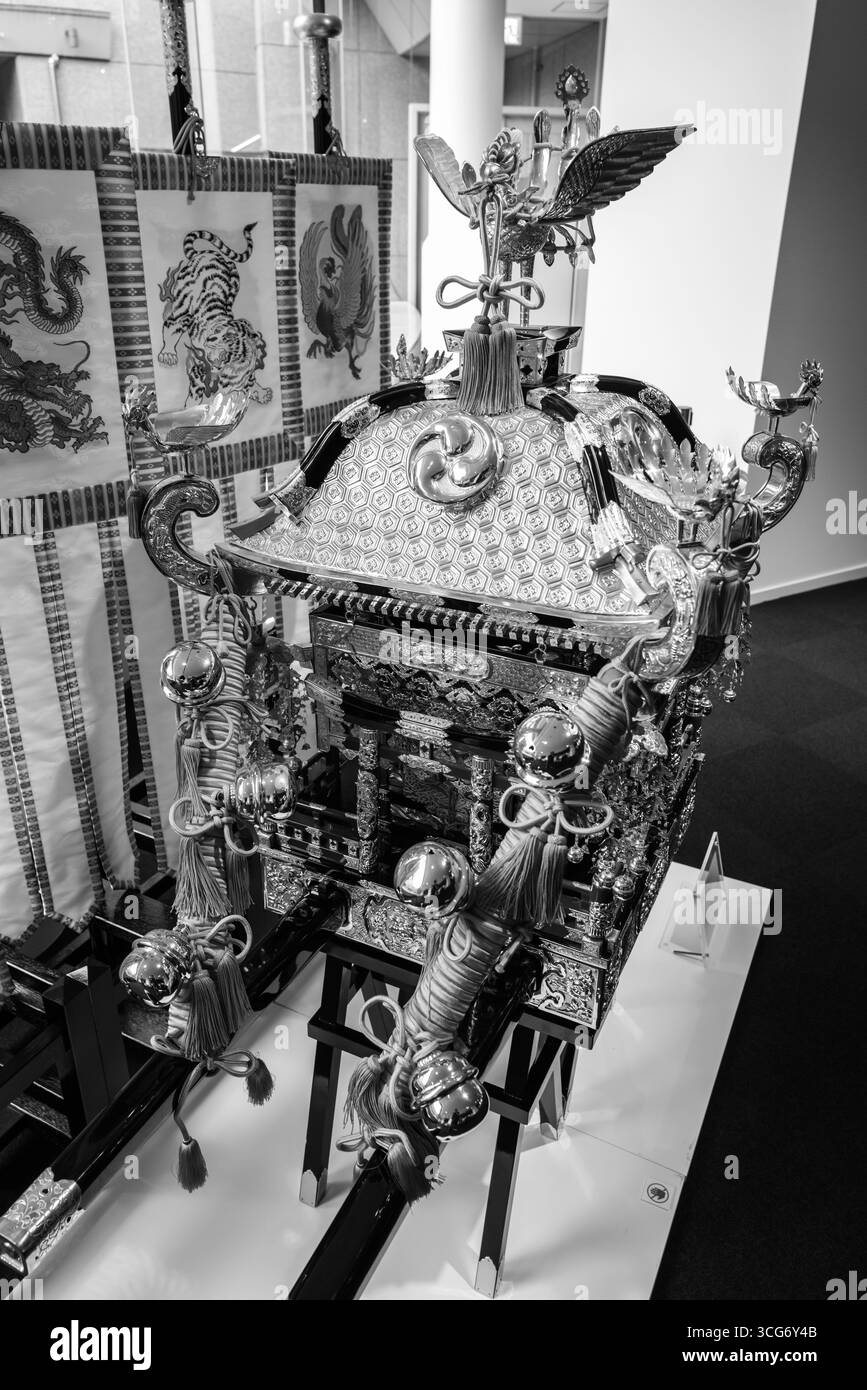 An ornate mikoshi shrine displayed indoors symbolizes Japanese culture ...