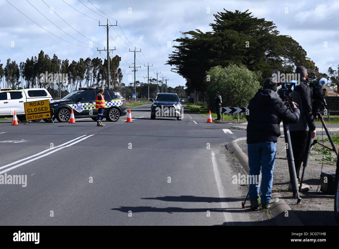 Victoria Police at a road block leading to the scene of a fatal school ...