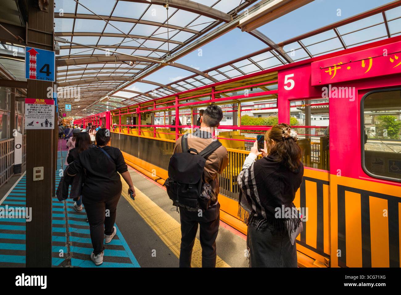 Tourist walking on train platform to board the Sagano romantic train at ...