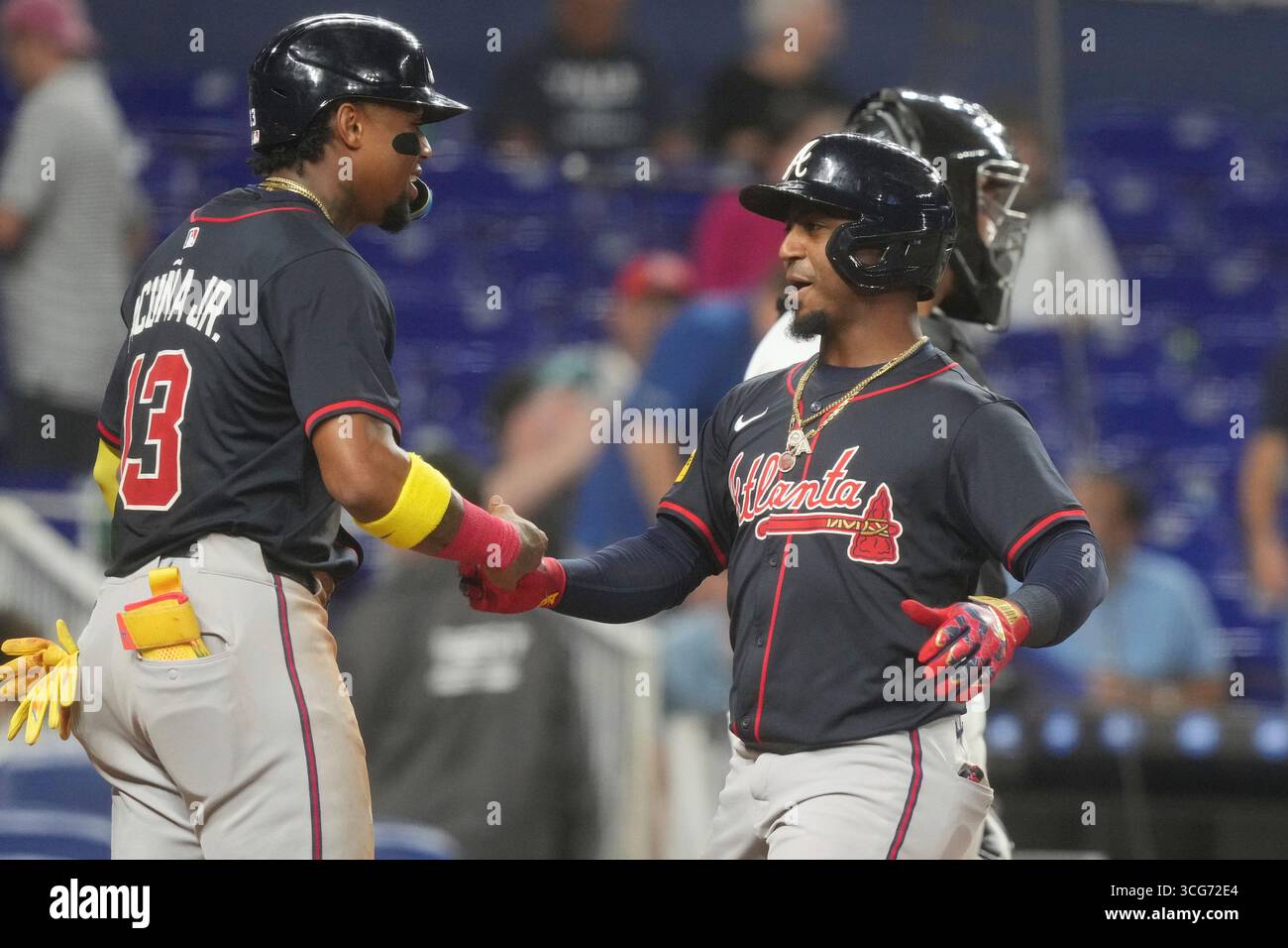 Atlanta Braves' Ronald Acuña Jr. (13) and Ozzie Albies celebrate after scoring on a three-run ...