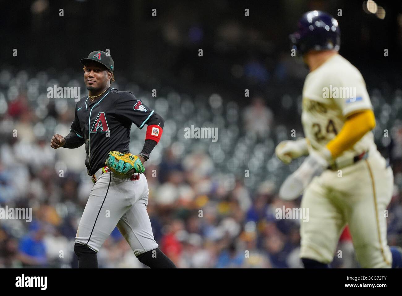 Arizona Diamondbacks' Geraldo Perdomo talks with Milwaukee Brewers ...