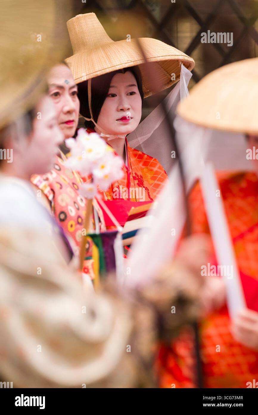 Group of women wearing historical attire featuring orange kimono and ...