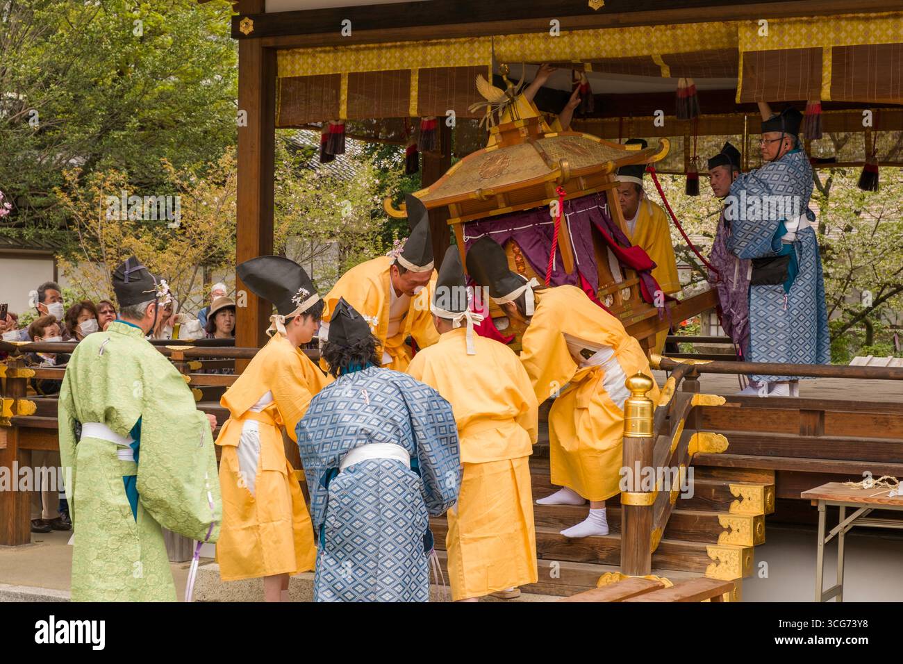 Men in traditional Shinto attire carrying Mikoshi sacred religious ...