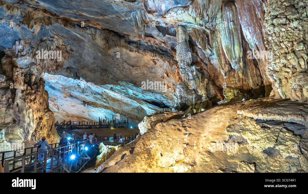 Tourists visit on wooden walkway through scenic natural corridor ...