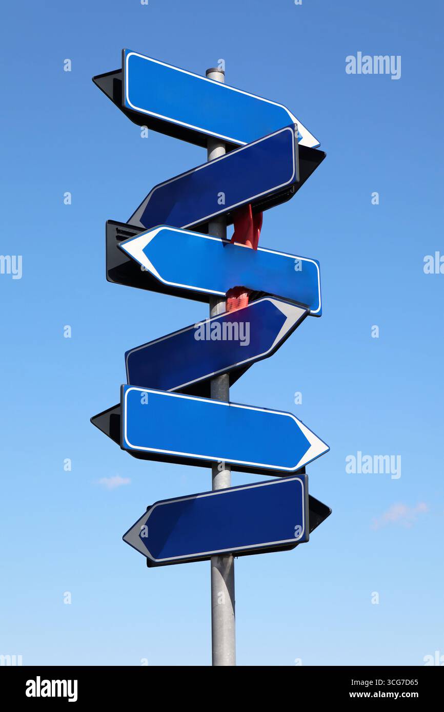 Multiple blank blue arrow signs pointing in various directions against ...