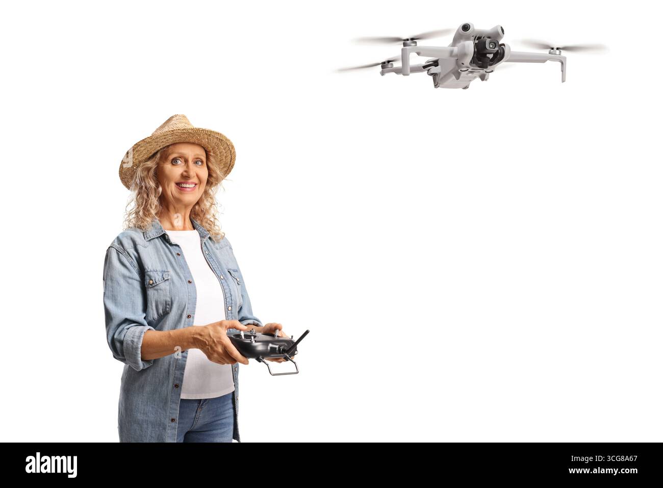 Middle aged woman flying a drone isolated on white background Stock ...