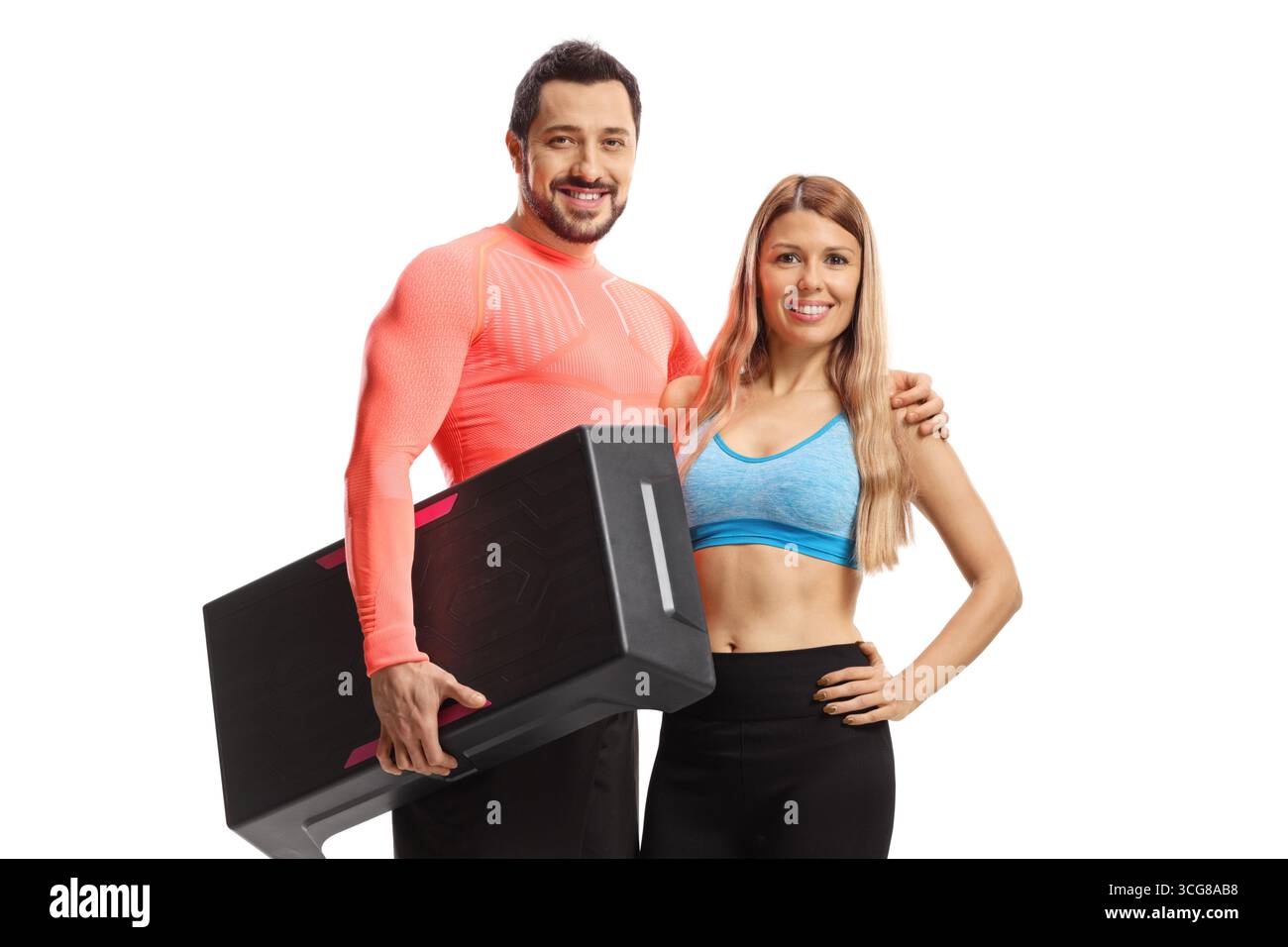 Man holding a stepper platform and posing with a young woman in ...