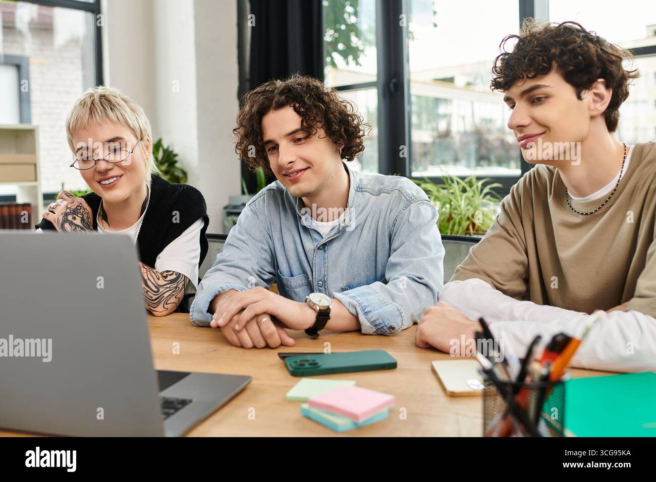 Three young professionals attentively collaborate at a modern workspace, sharing ideas and ...