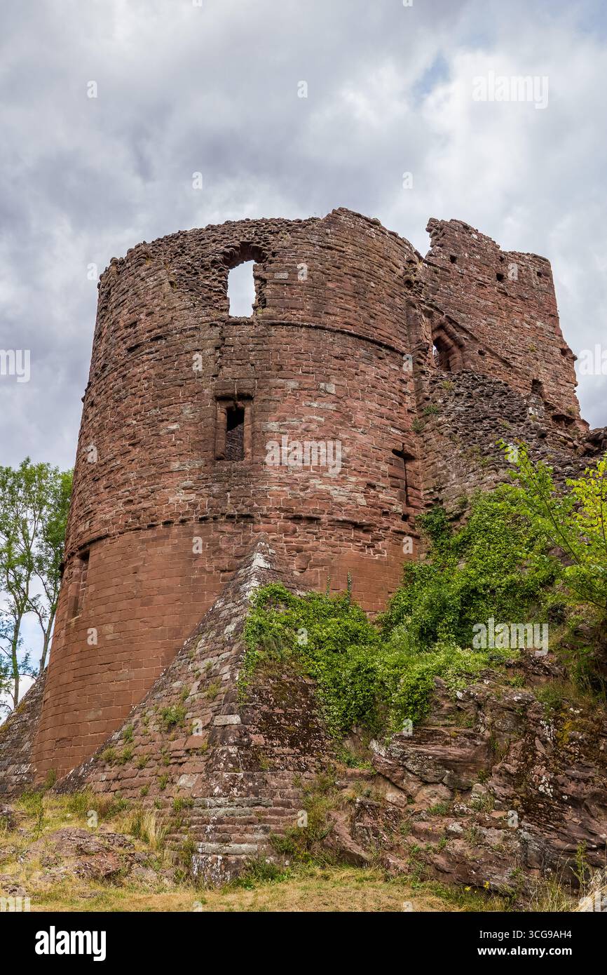 Crumbling walls of a medieval castle tower built on a rocky outcrop ...