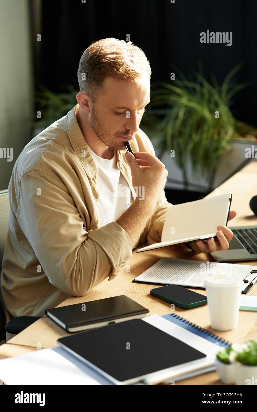 Young professional contemplates desk hi-res stock photography and ...