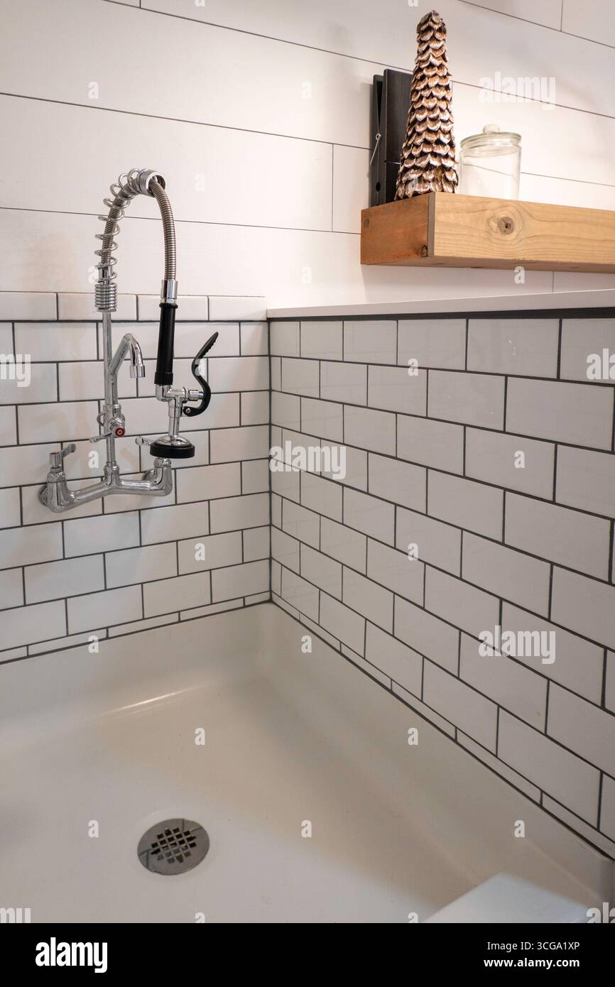 Modern tiled laundry room in a residential suburban house in Montana ...