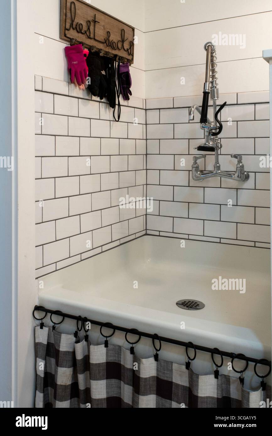Modern tiled laundry room in a residential suburban house in Montana ...