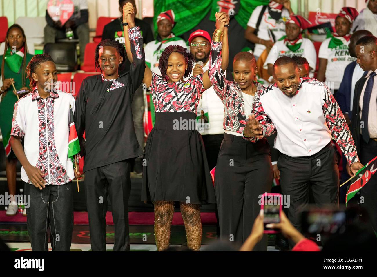 Prominent Kenyan activist Boniface Mwangi, right, bows down with his ...