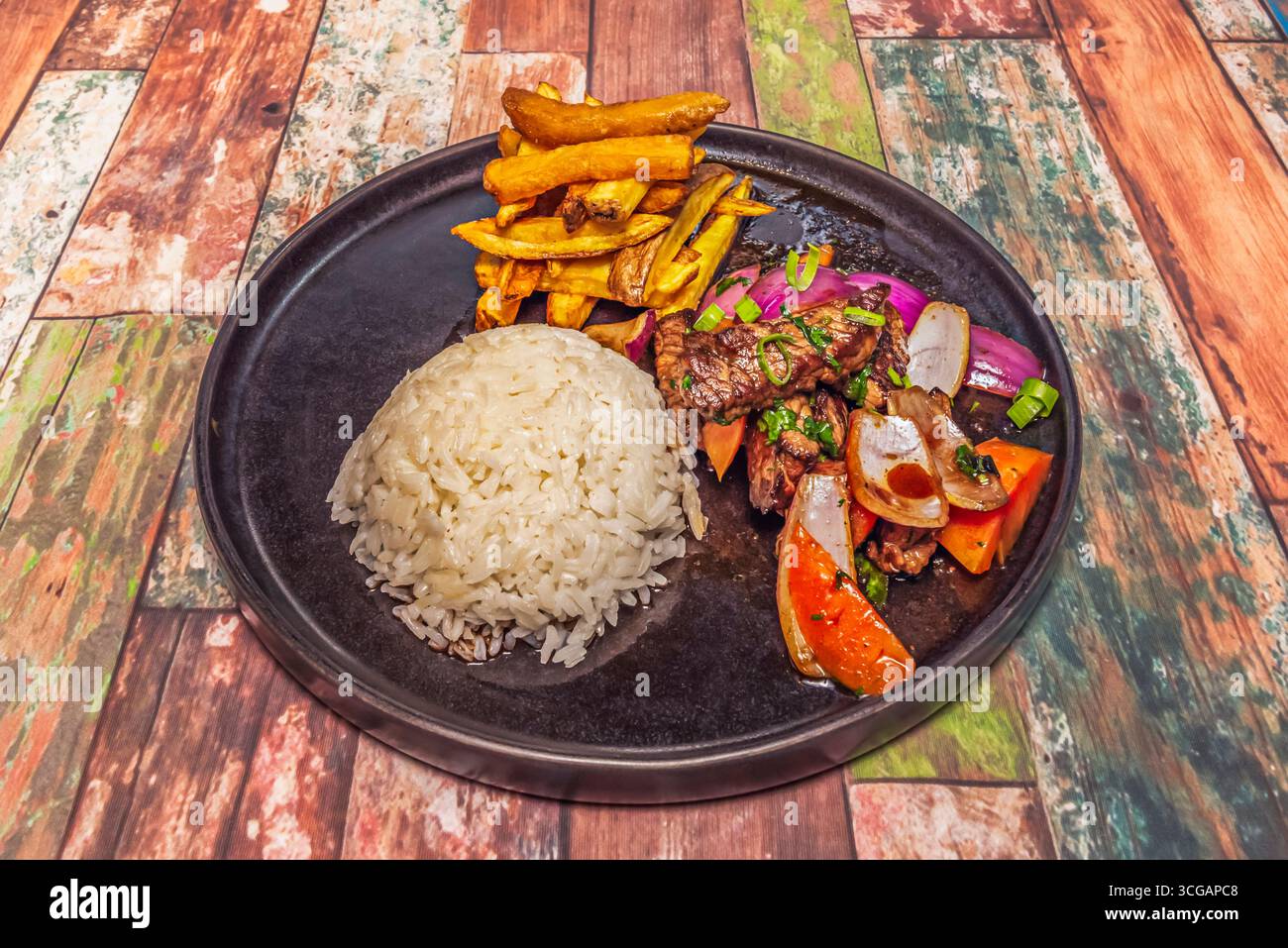 Classic lomo saltado with strips of tender beef tenderloin, wedged ...