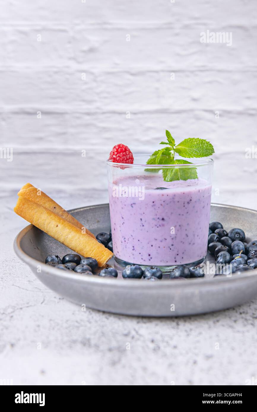 Artistic spill effect: Blueberry smoothie falling onto a pile of ...