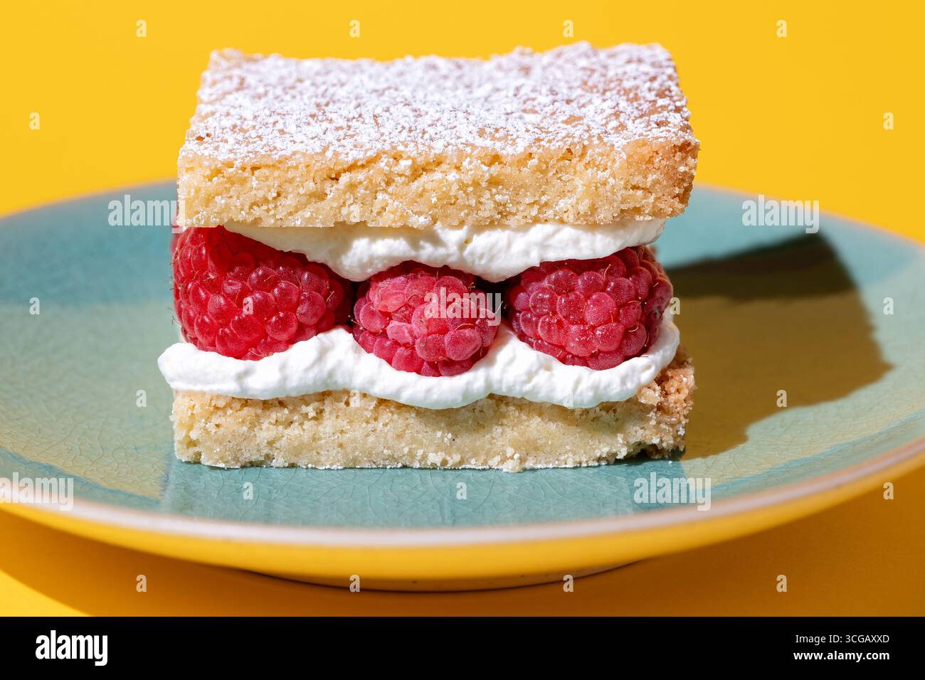 UK. A freshly made cream slice. The cake is made using shortbread for ...