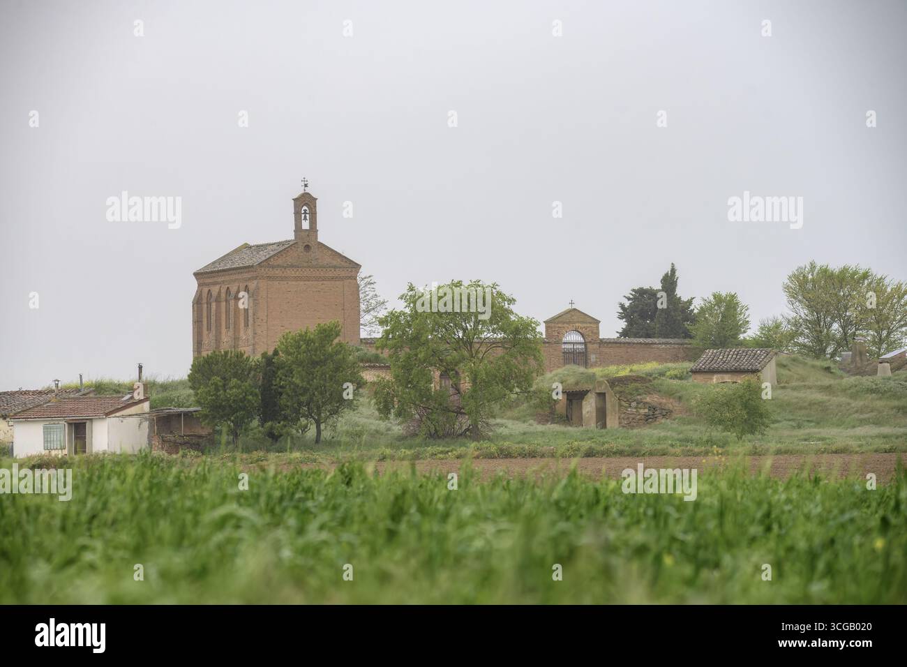 Chapel with pointed windows and bell gable next to a rural cemetery in ...