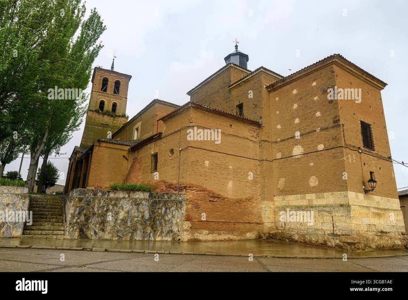 Large brick church with vertical bell tower, masonry base and multiple ...