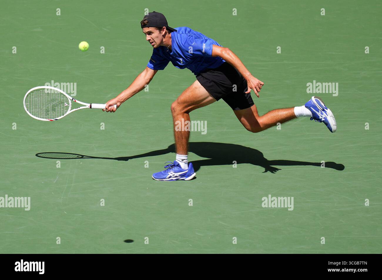 Zachary Svajda, of the United States, chases down a shot from Novak ...