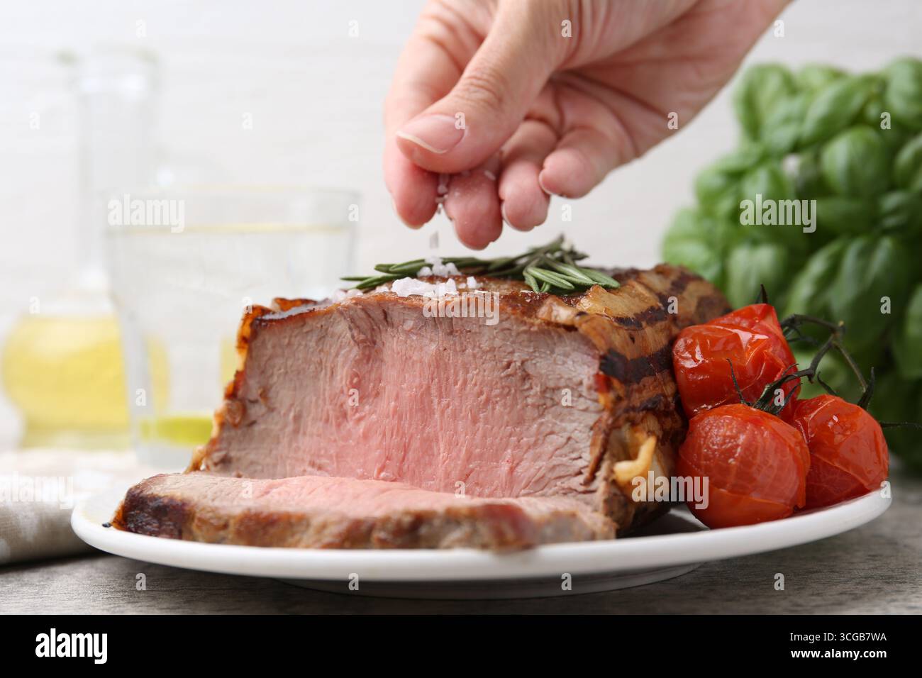Woman salting roasted beef hi-res stock photography and images - Alamy